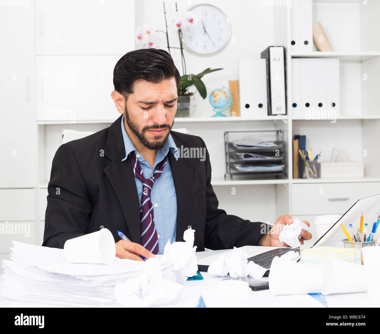 Spanish male worker is having complicated issue with project in office ...