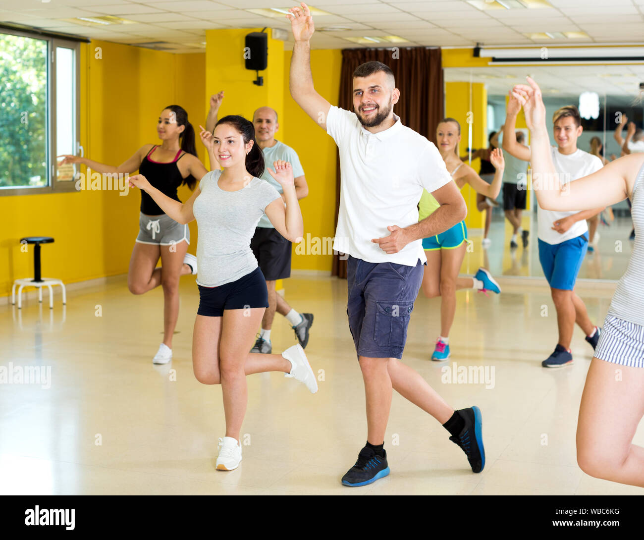 Smiling people dancing rock-and-roll in the hall Stock Photo - Alamy