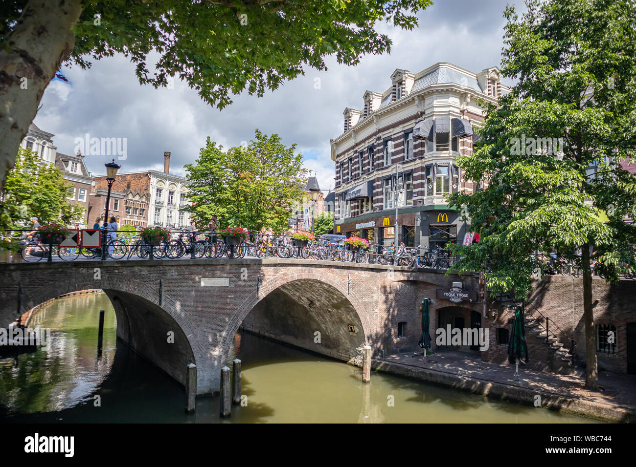 Utrecht, Netherlands - JULY 01, 2019: Stone bridge above river with ...