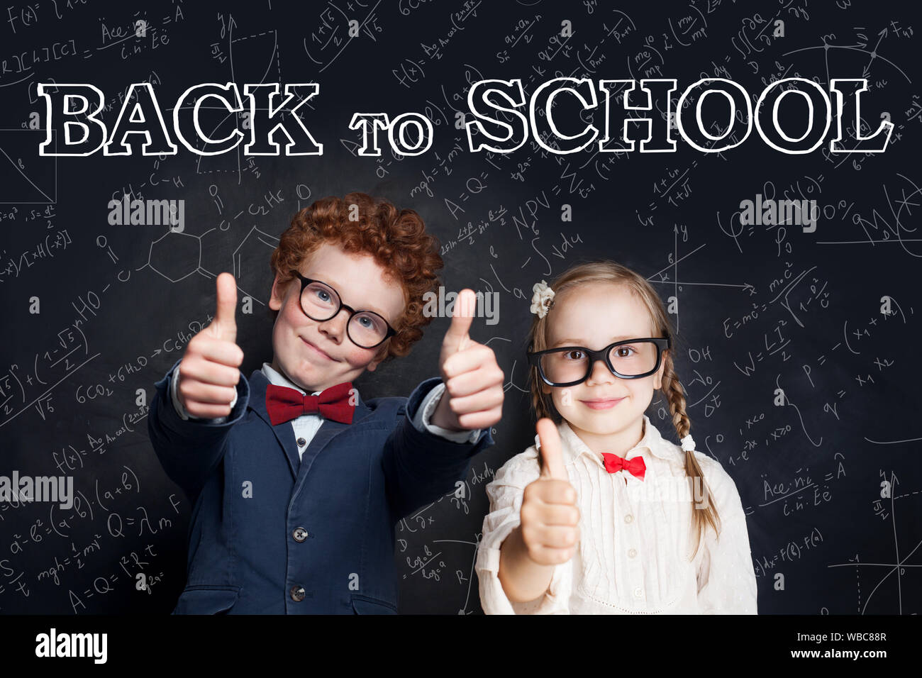 Successful clever children in school uniform showing thumb up on ...