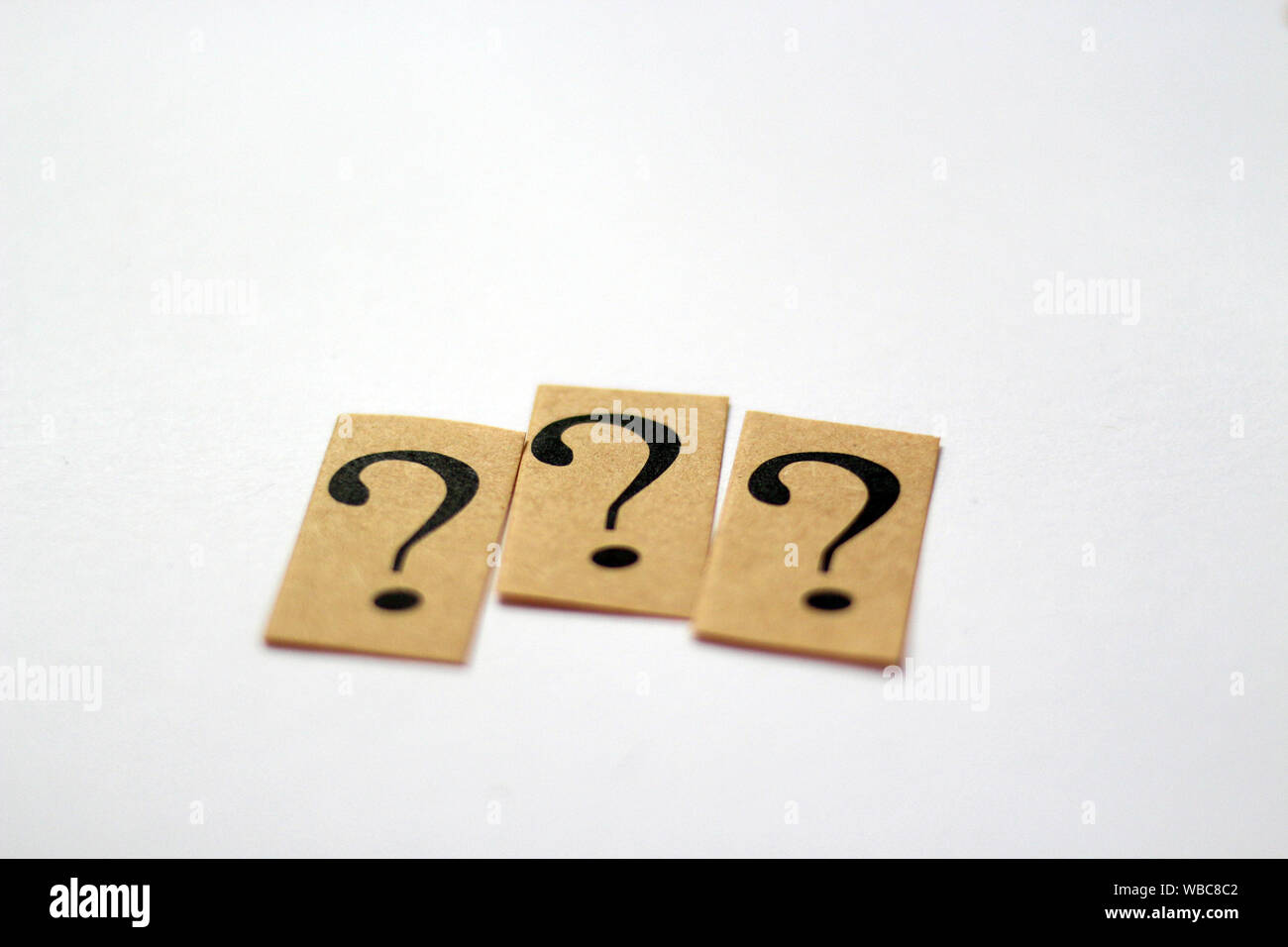 Closeup shot of a lot of small papers with Question marks and letters ...