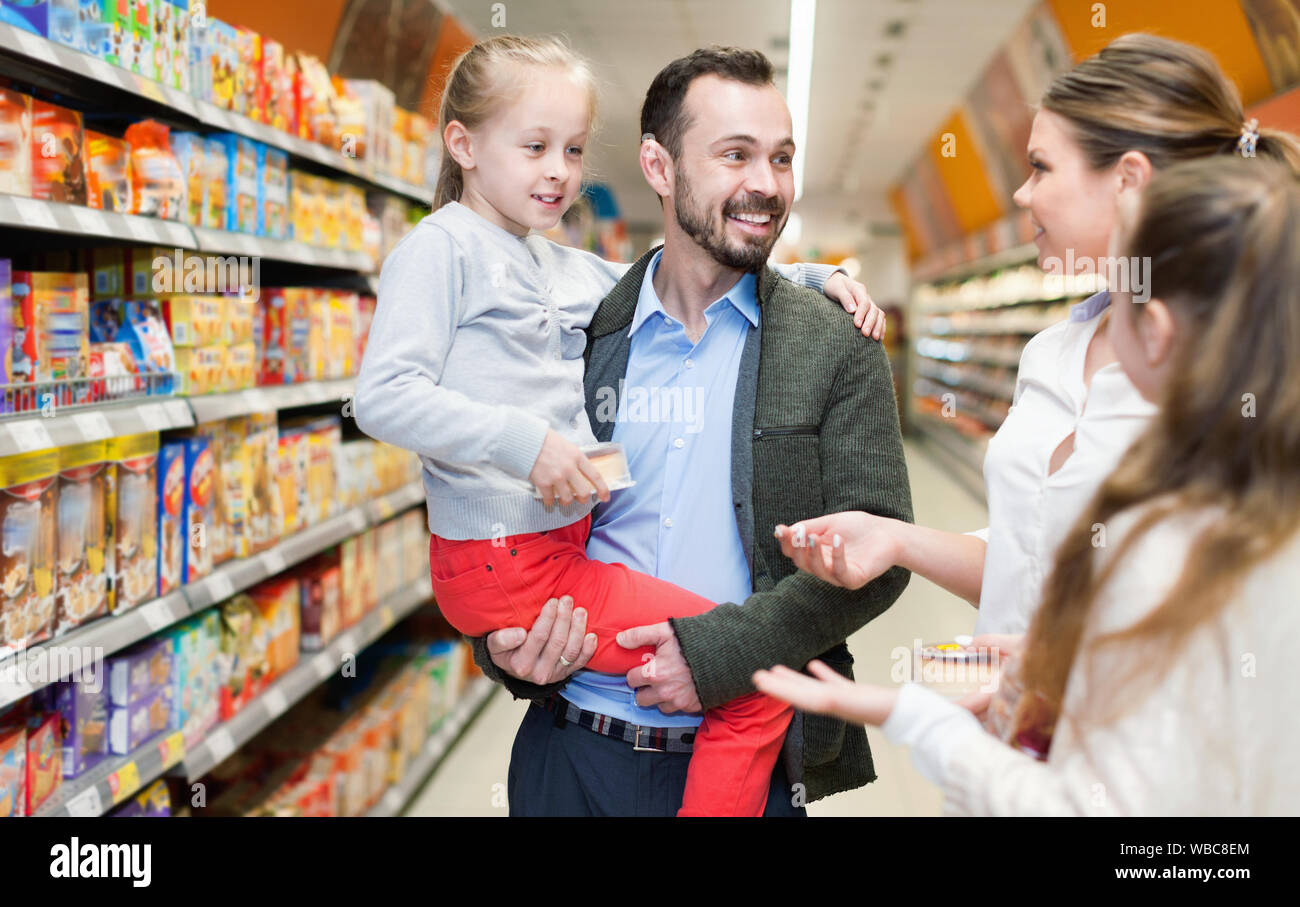 Happy cheerful positive family is talking about shopping in the ...