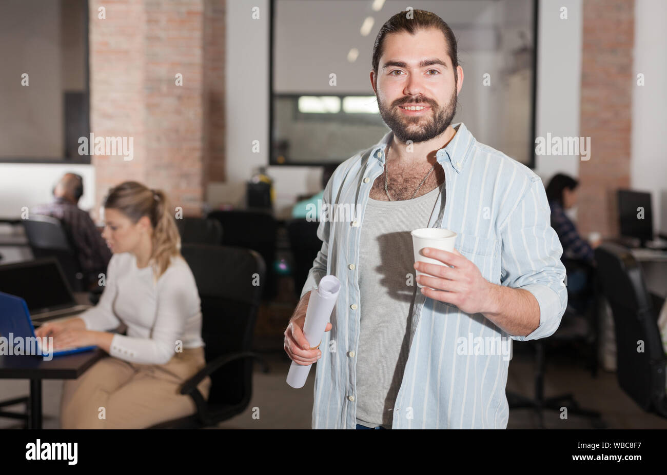 Portrait of cheerful male entrepreneur during daily work in modern ...