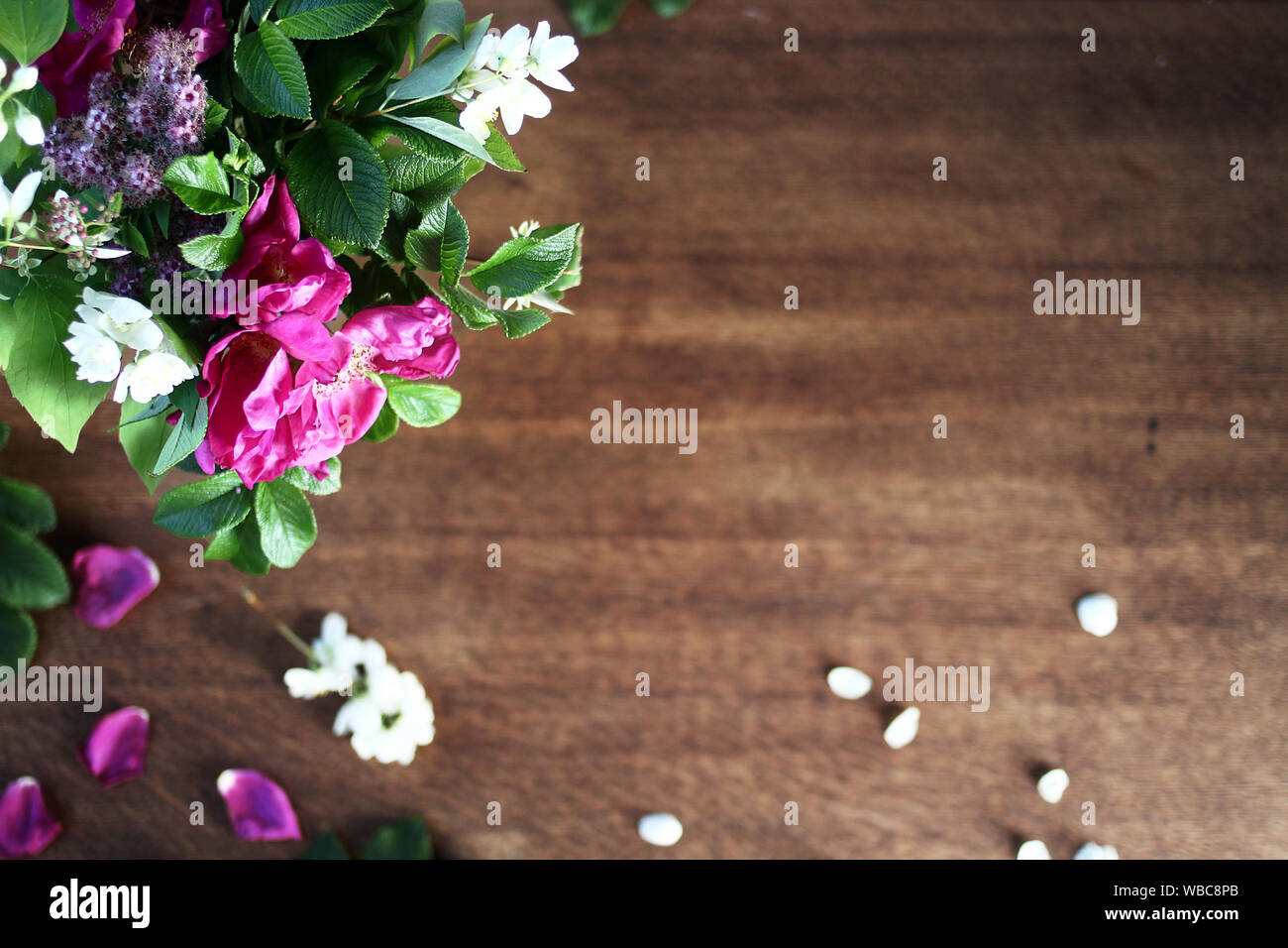 Top view of wild romantic flowers on a brown wooden table Stock Photo ...
