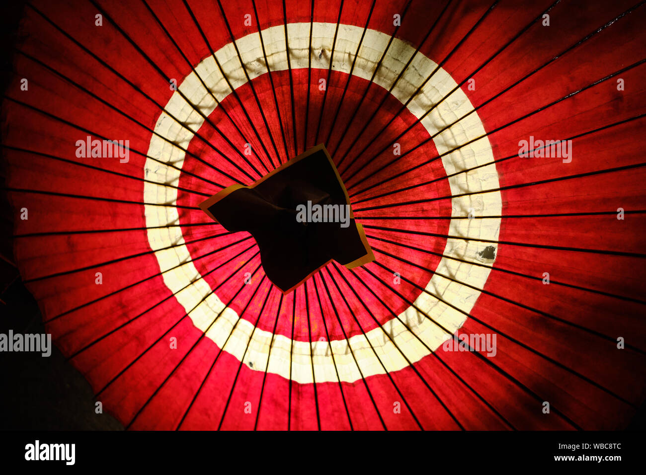 Red paper Japanese parasol or higasa backlit at night Stock Photo - Alamy