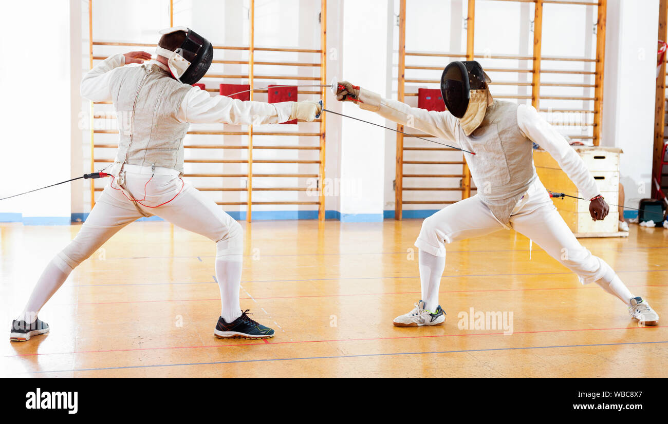 Portrait of glad cheerful positive athletes at fencing workout ...
