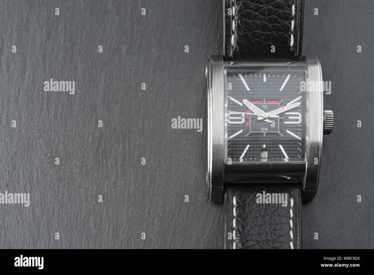 Elegant expensive square shaped wrist watch with black leather strap on ...