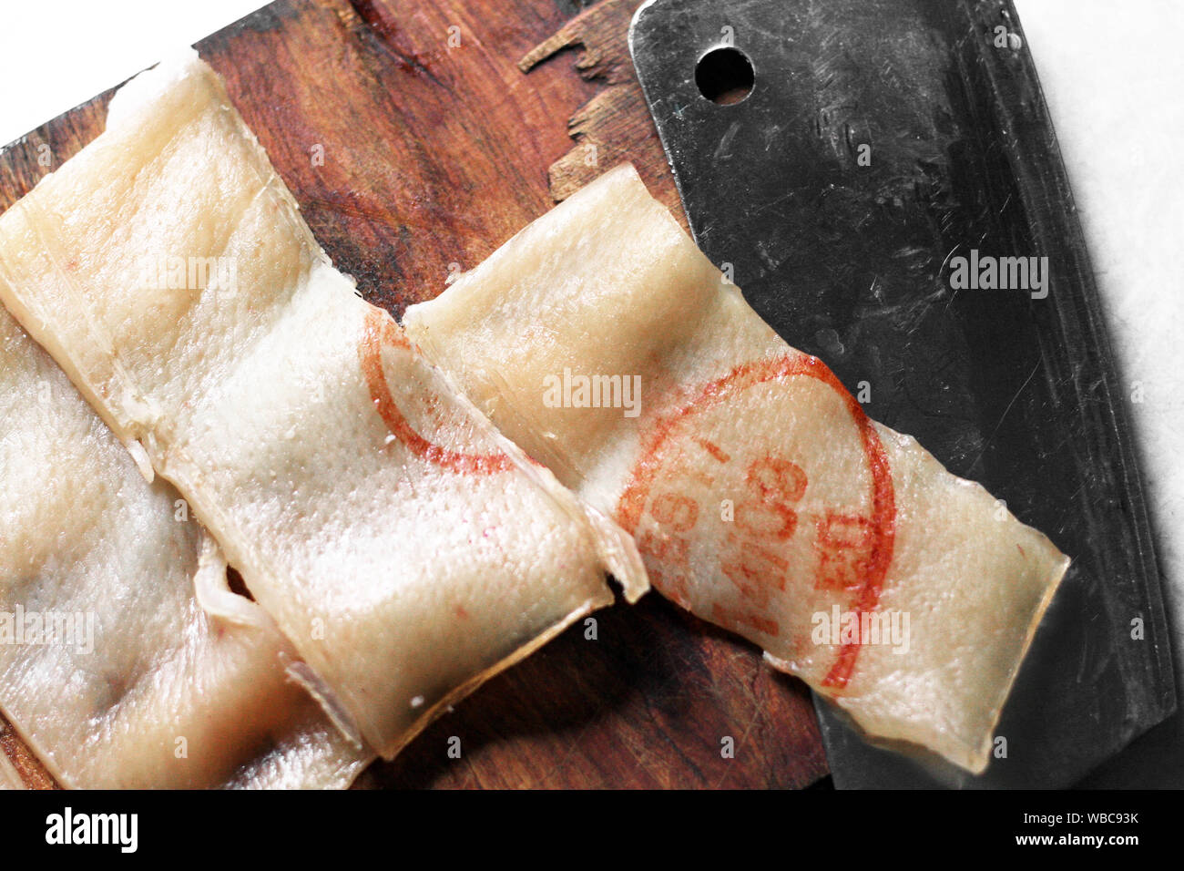 chopped skin meat with butchers knife Stock Photo - Alamy