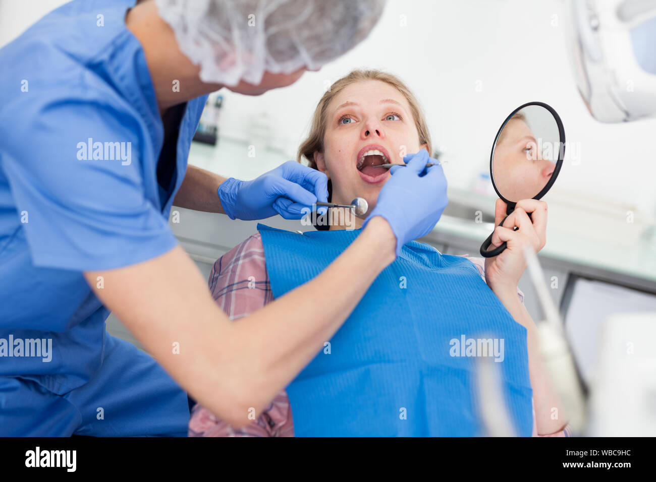 Young woman on dental checkup in modern dentist office Stock Photo - Alamy