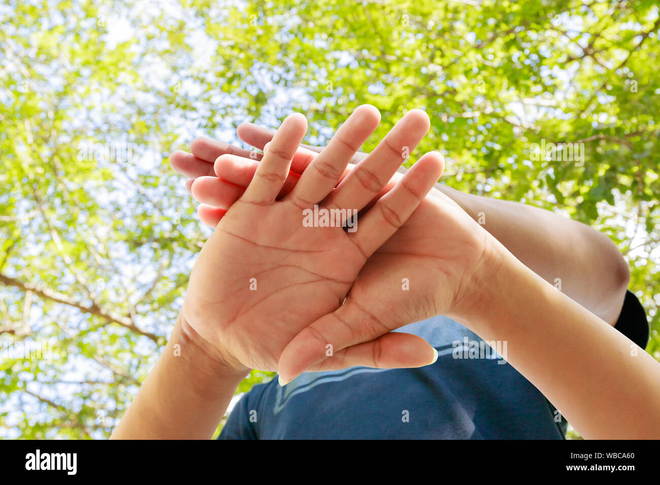 young people joining hands together in nature background. Concept unity ...
