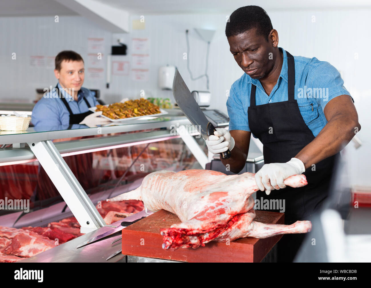 Butcher cutting meat african man hi-res stock photography and images ...