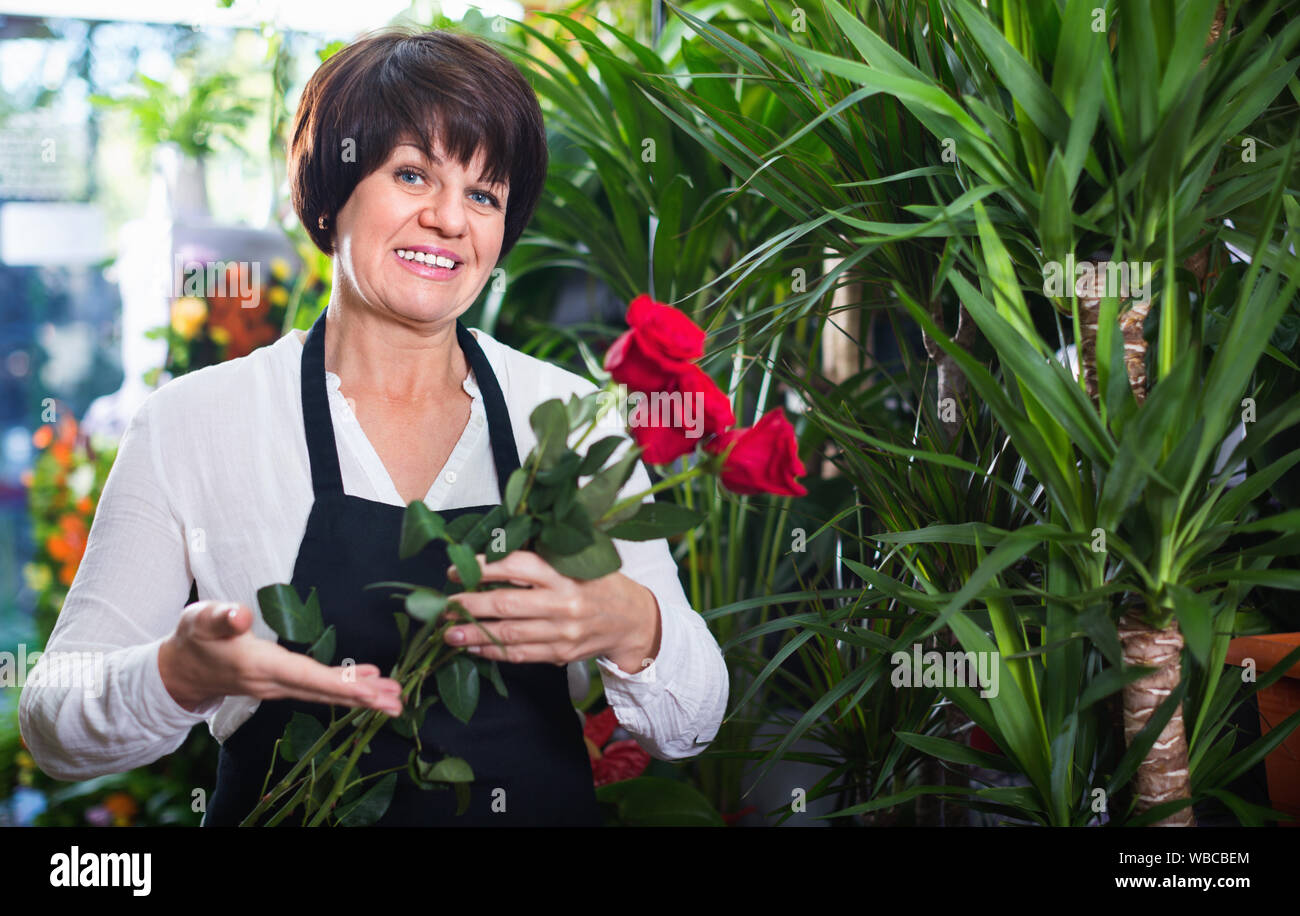 Woman tending roses hi-res stock photography and images - Alamy