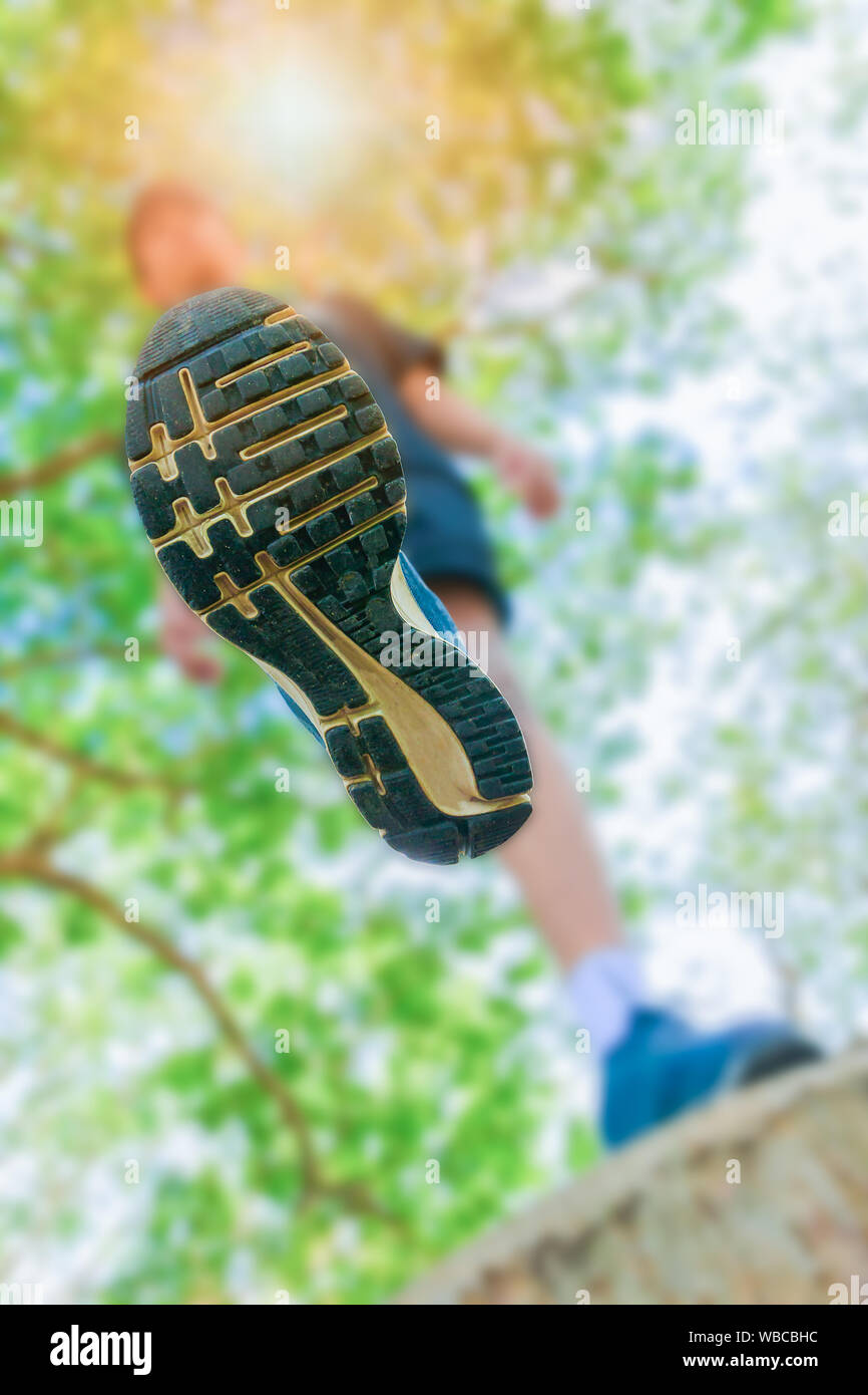 running feet male view from below in runner jogging exercise with old ...