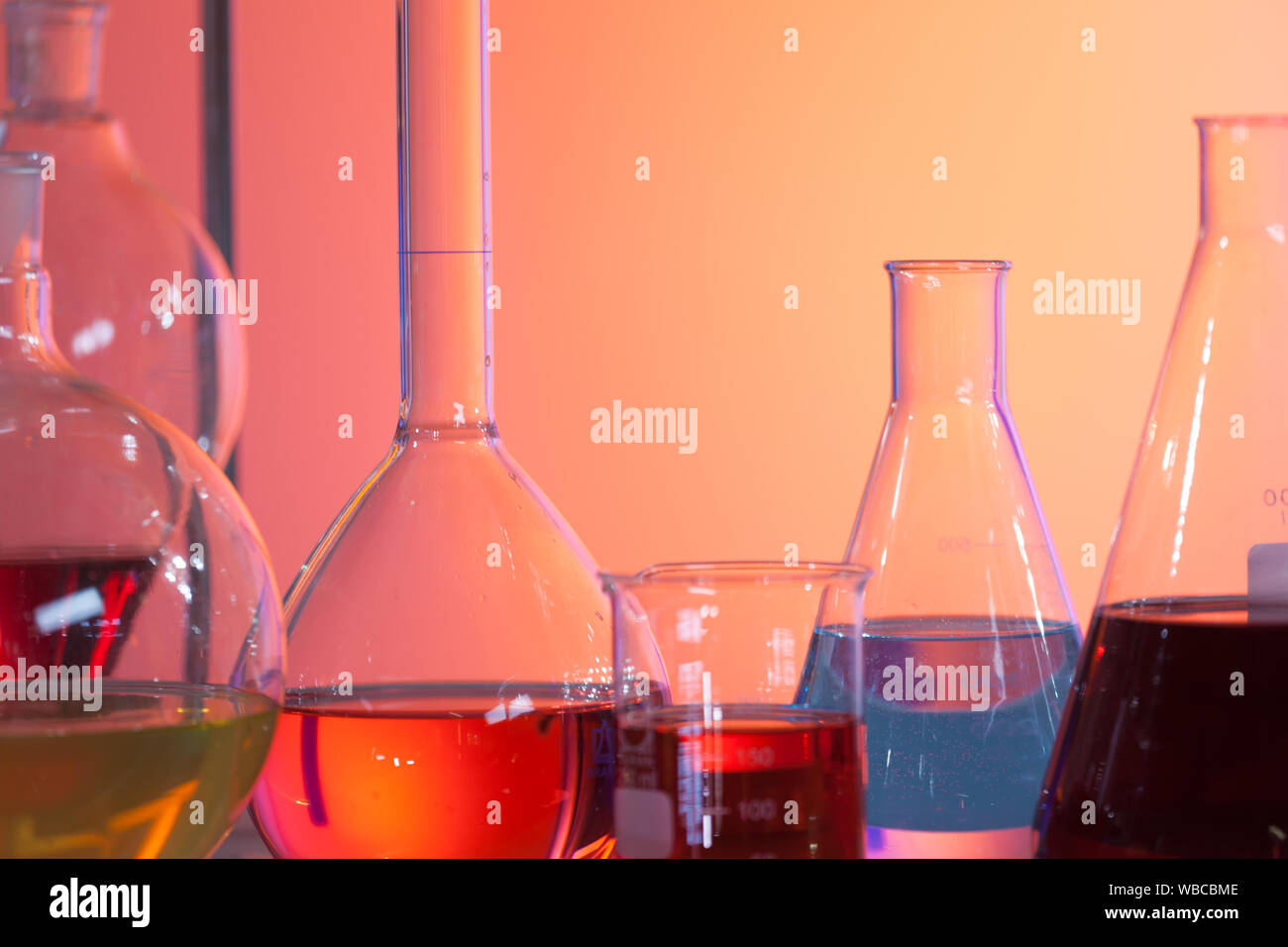 Backlit laboratory test flask containing colorful liquids Stock Photo ...