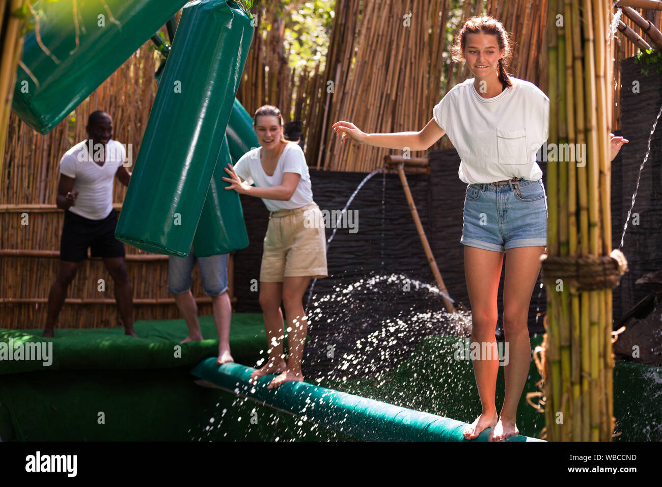 Obstacle course over the water - fun adventure in an amusement park ...