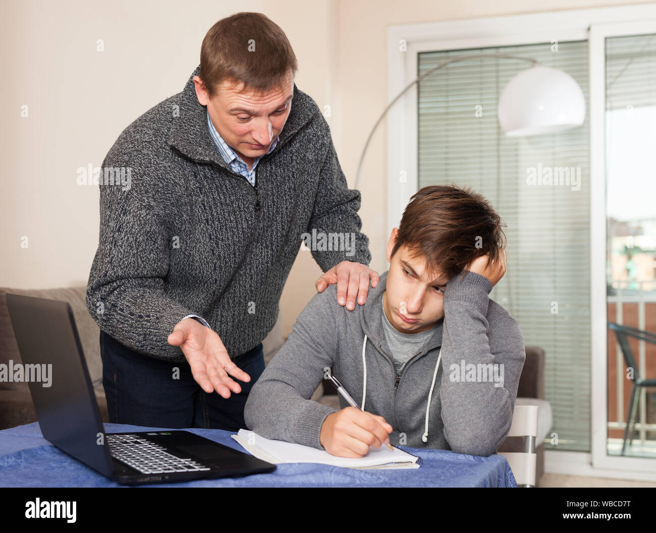 Father scolds his son for bad schooling Stock Photo - Alamy