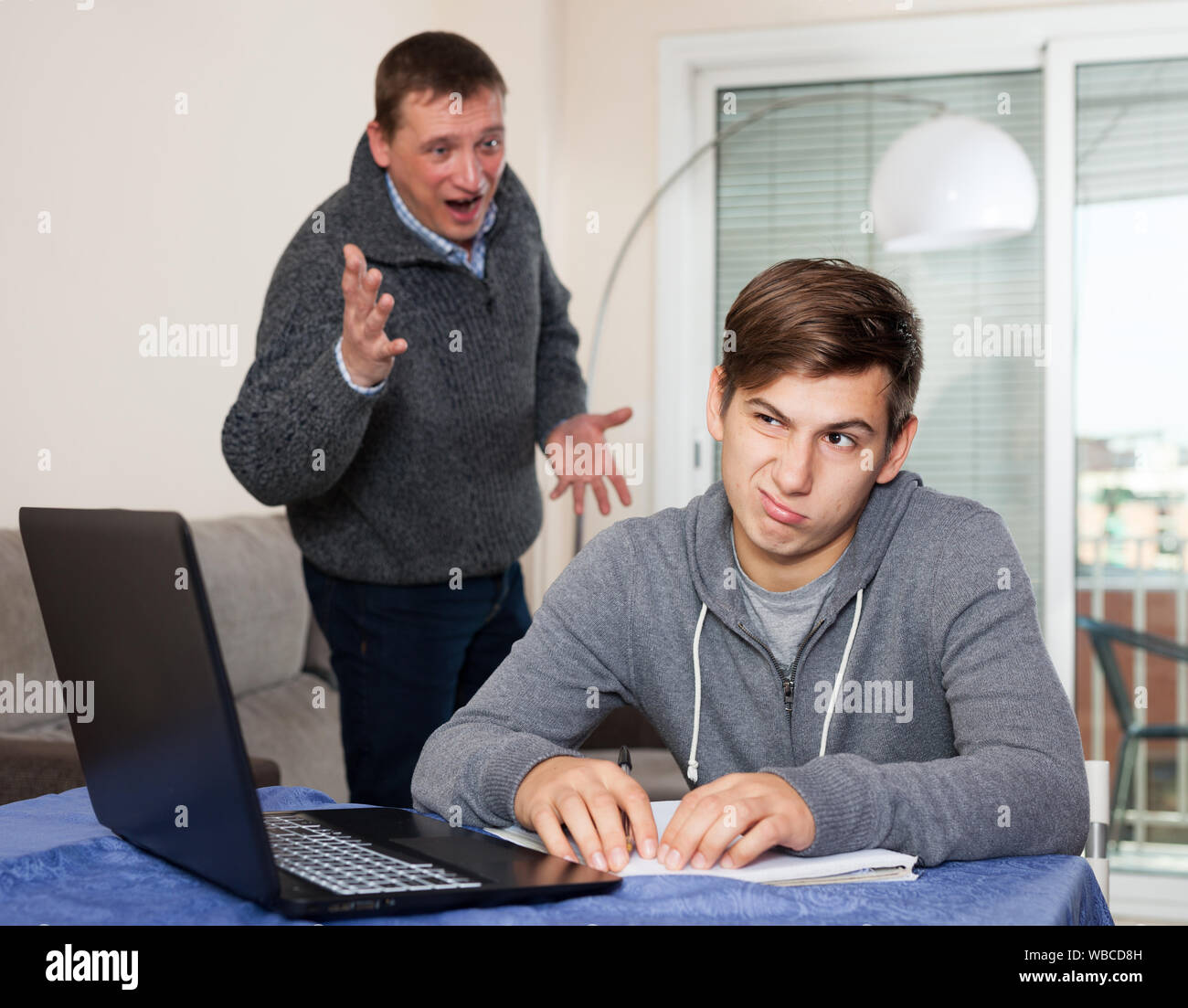 Father scolds his son for bad schooling Stock Photo - Alamy