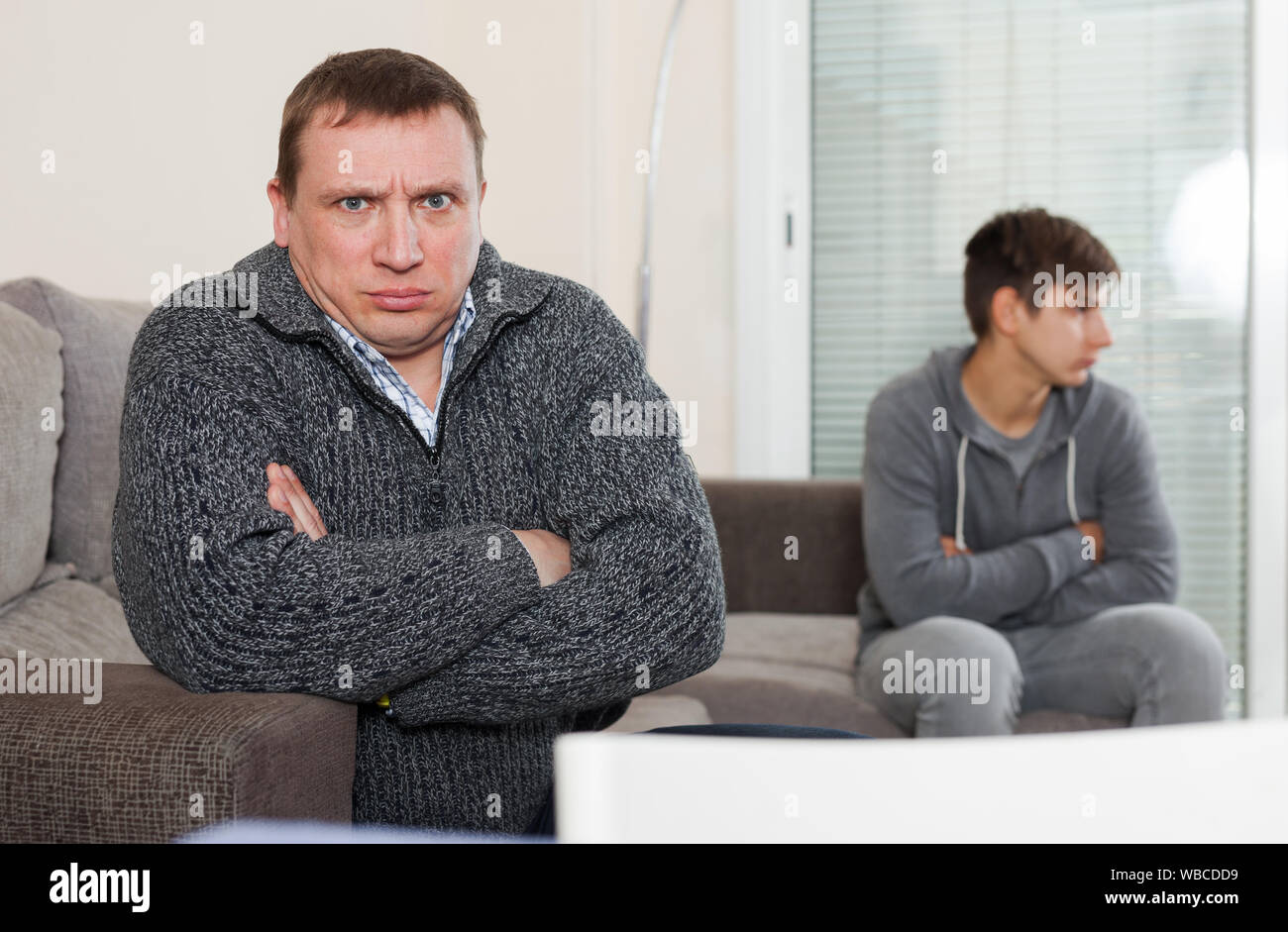 Outraged father unhappy with his son teenager Stock Photo - Alamy