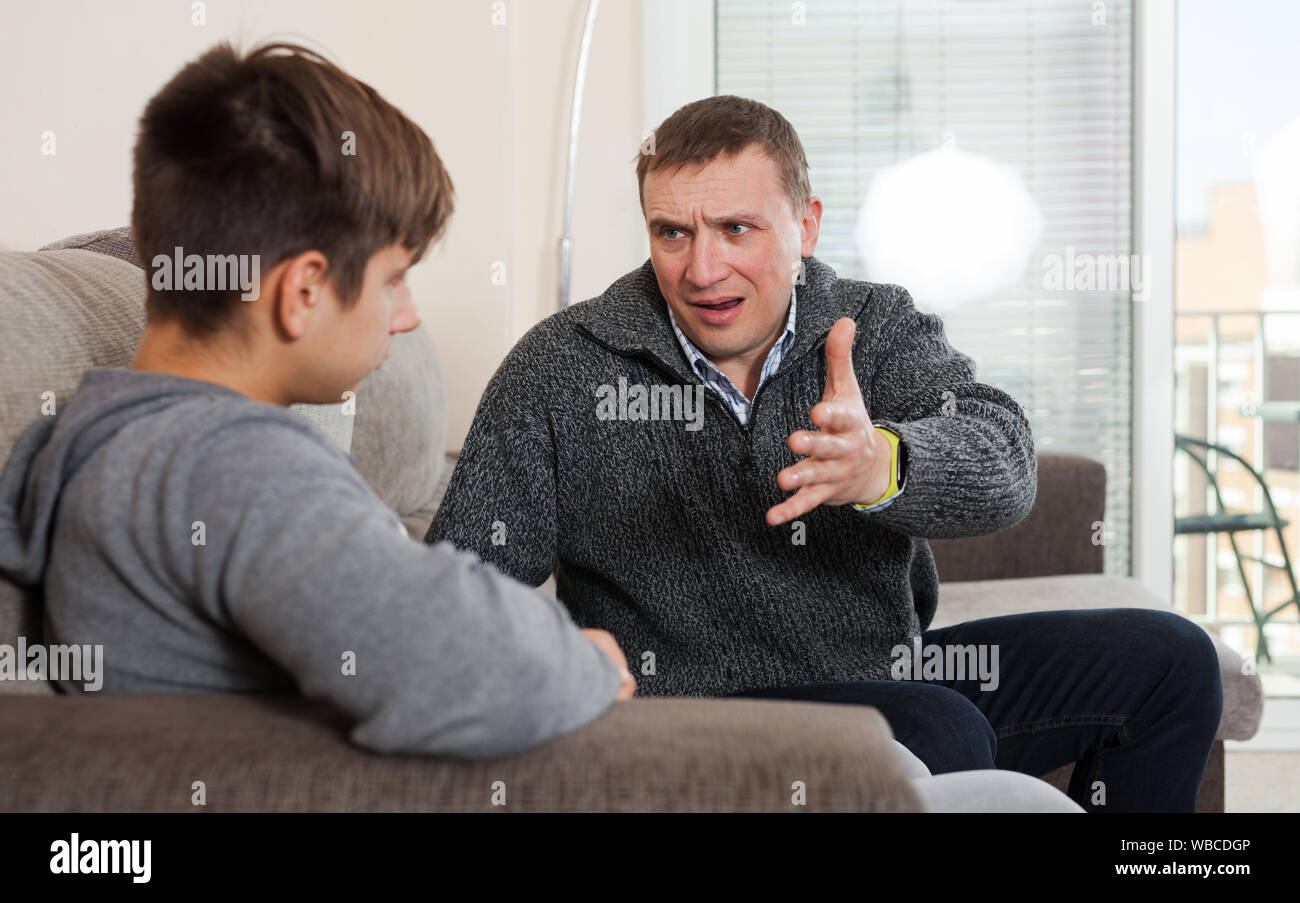 Angry father screaming at offender son Stock Photo - Alamy