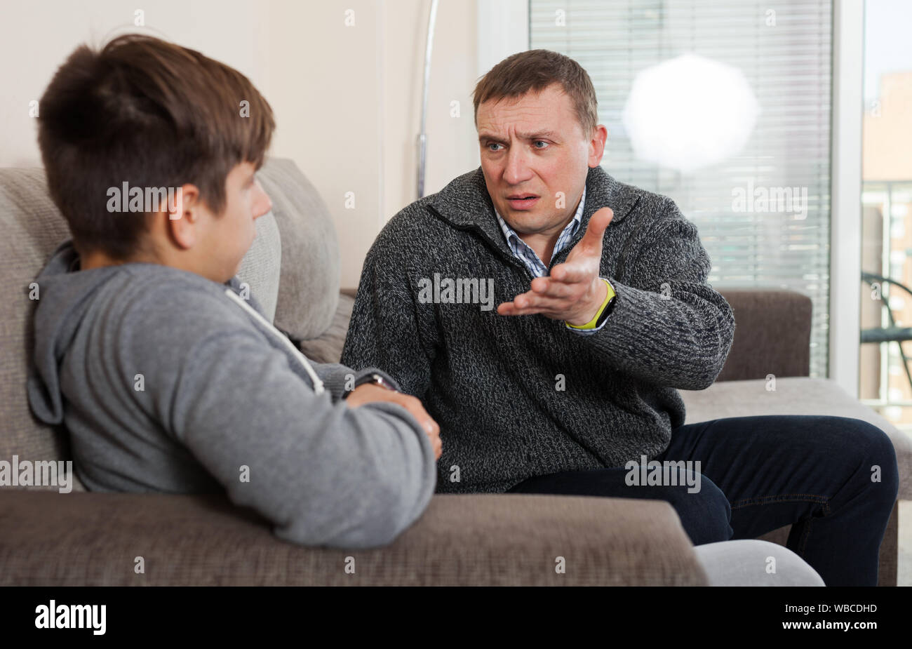 Angry father screaming at offender son Stock Photo - Alamy
