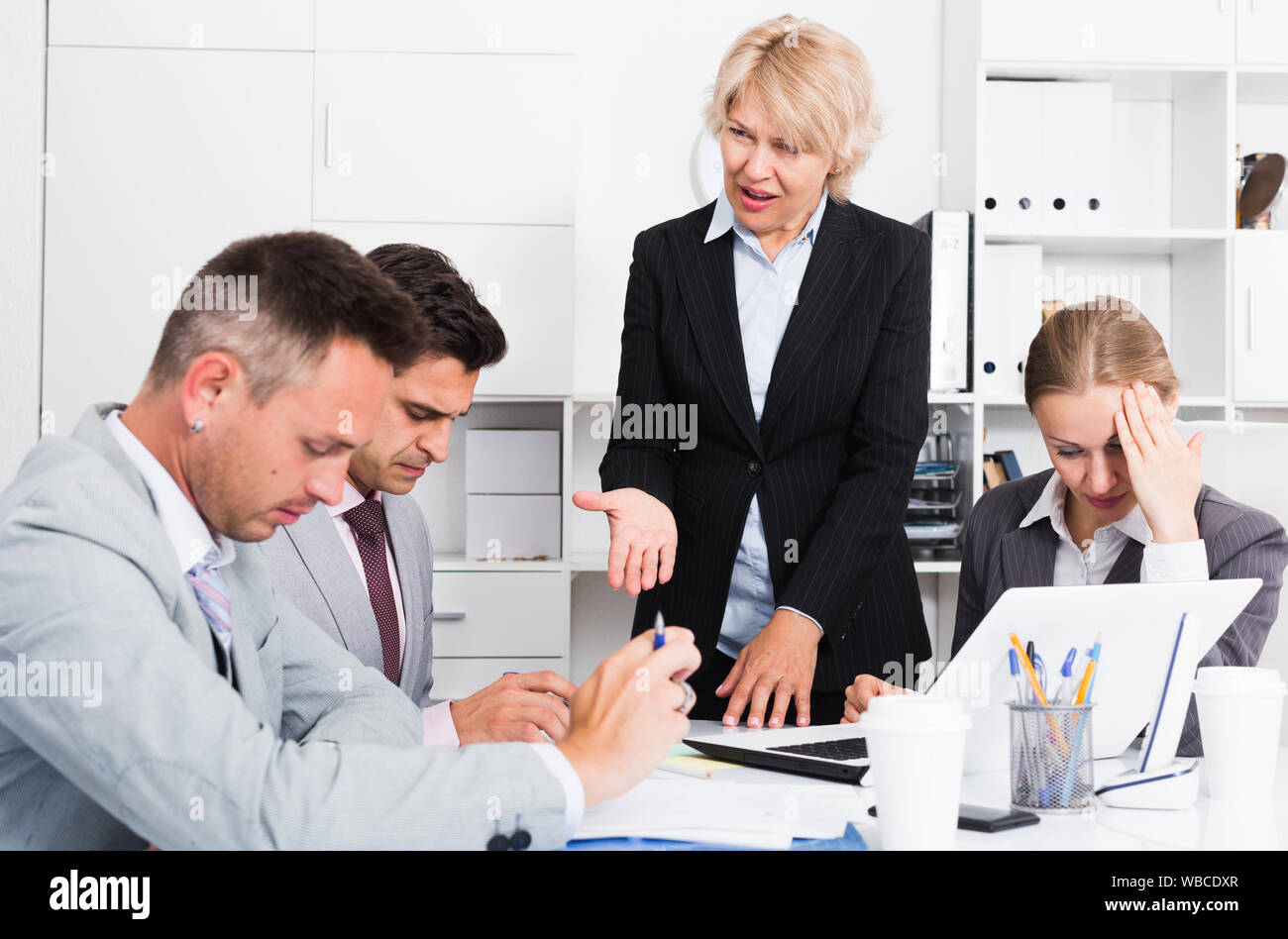 Outraged female manager expressing dissatisfaction with teamwork of ...