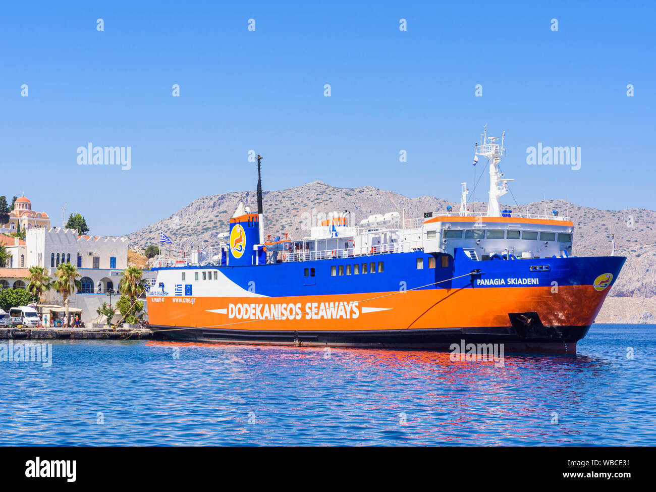 The small Greek ferry, Panagia Skiadeni in the port of Symi, Dodecanese ...