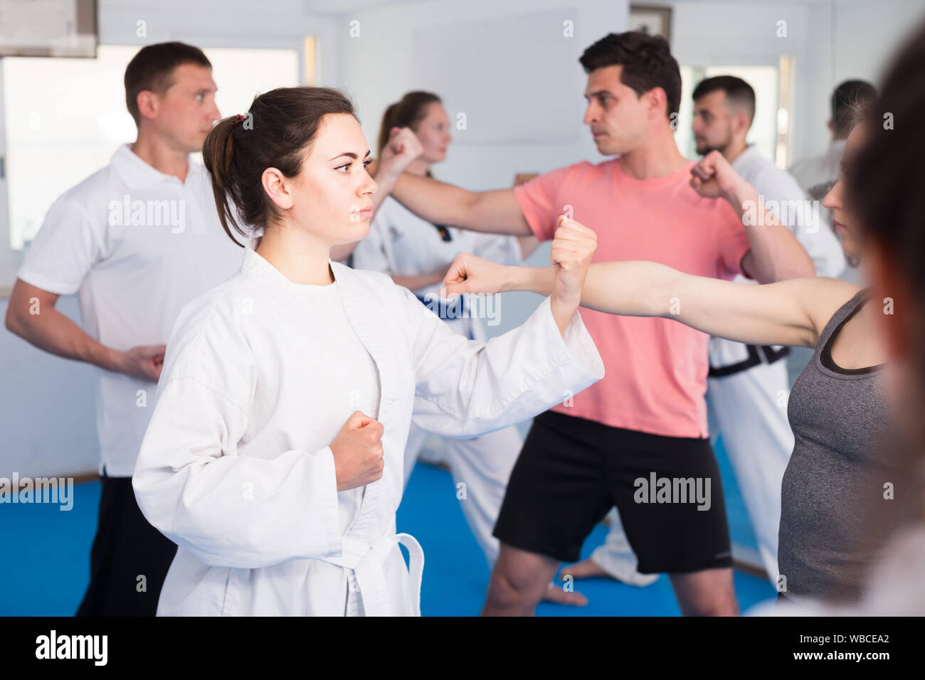 Lesson on karate in a mixed group of trainees in the class for martial ...