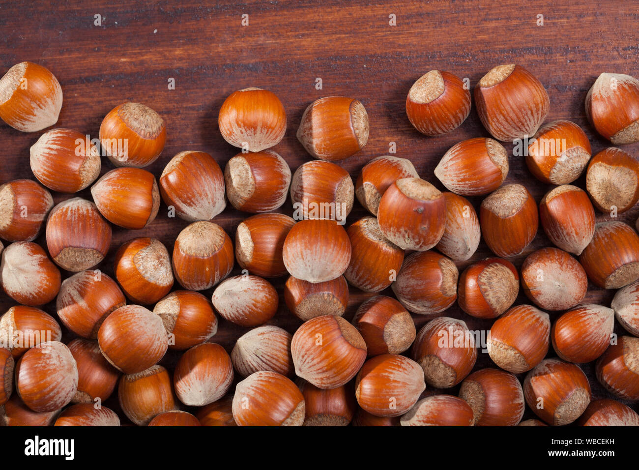 Picture of dry unpeeled walnut on wooden surface, nobody Stock Photo ...