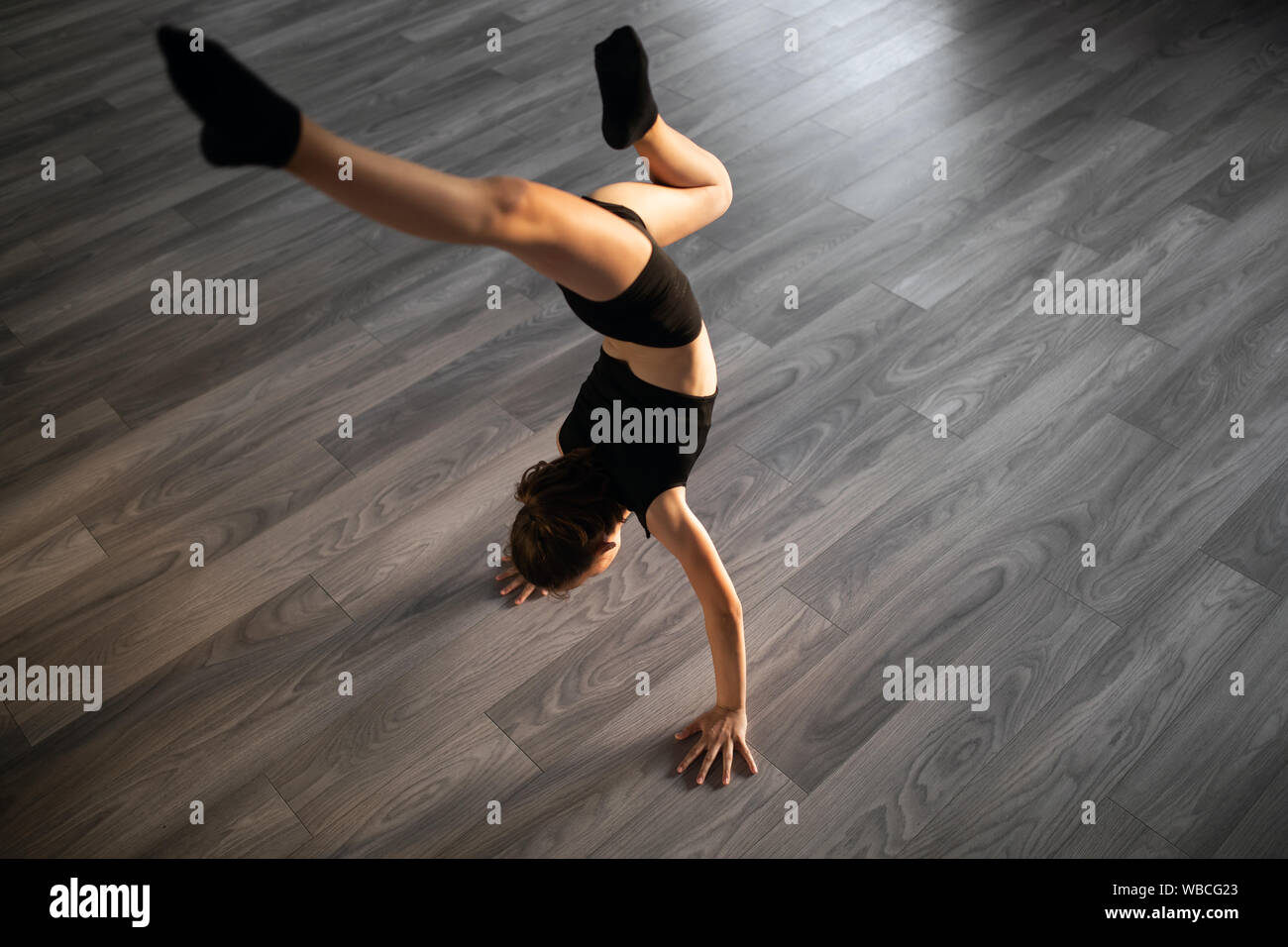 Beautiful girl practicing and exercising modern ballet at dance school ...