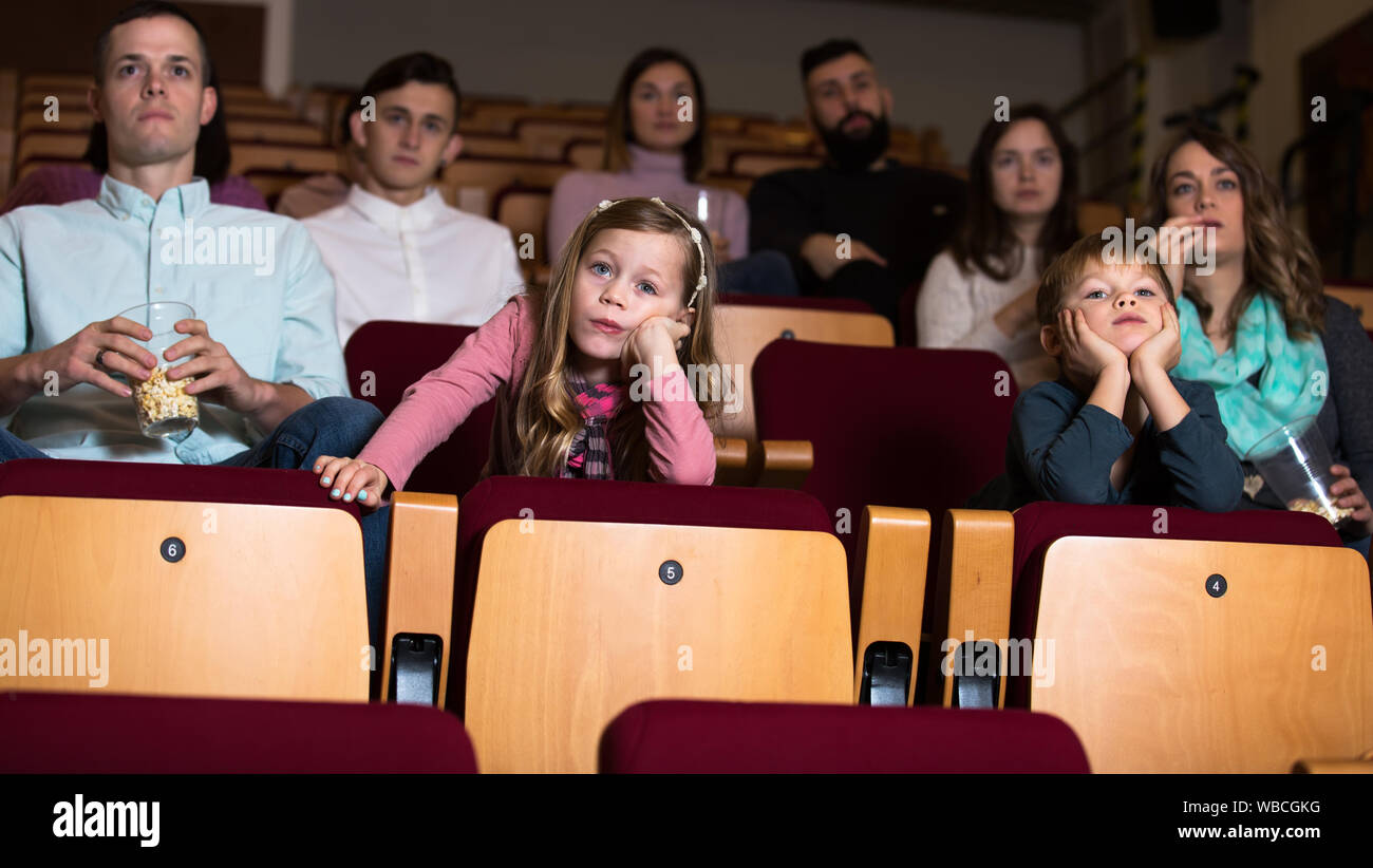 Child is bored watching movie in cinema house Stock Photo - Alamy