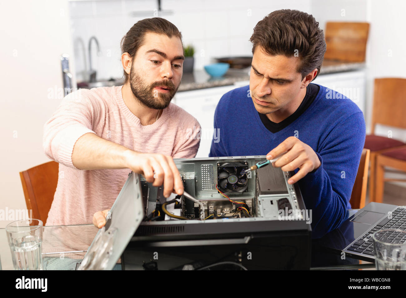 Two men repairing a desktop computer Stock Photo - Alamy