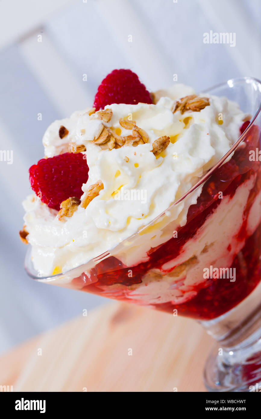 Festive Scottish summer dessert Cranachan with raspberries folded into ...
