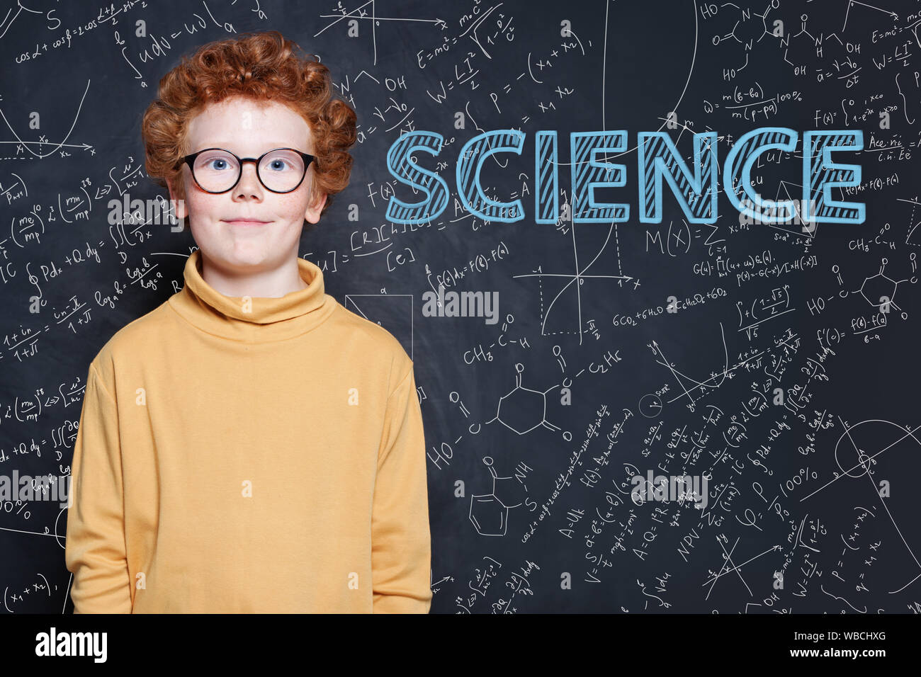 Smart little boy with red ginger hair on science background Stock Photo ...