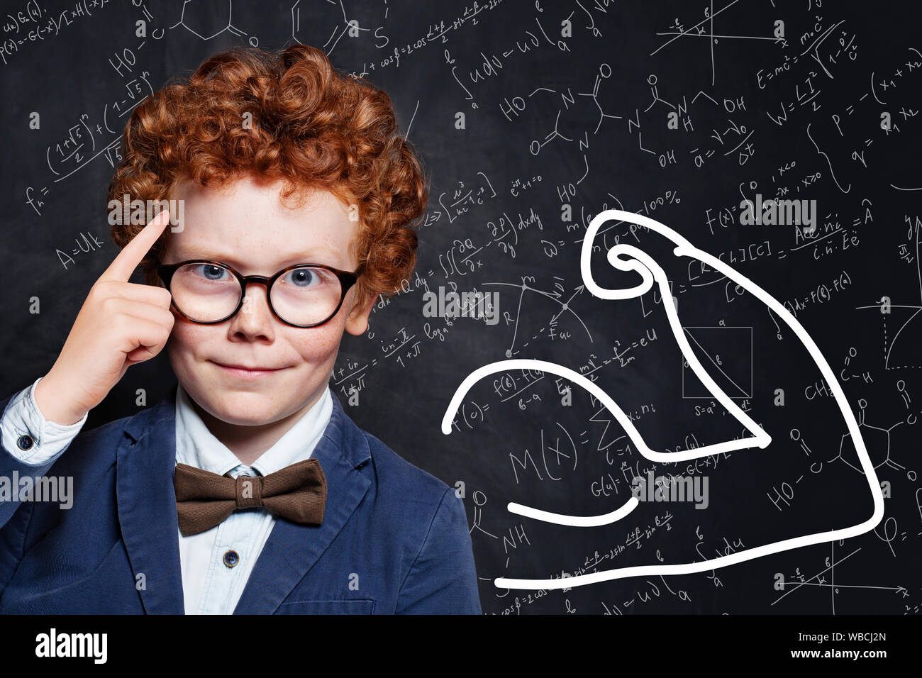 Clever little boy with red ginger hair on science background. Learn ...