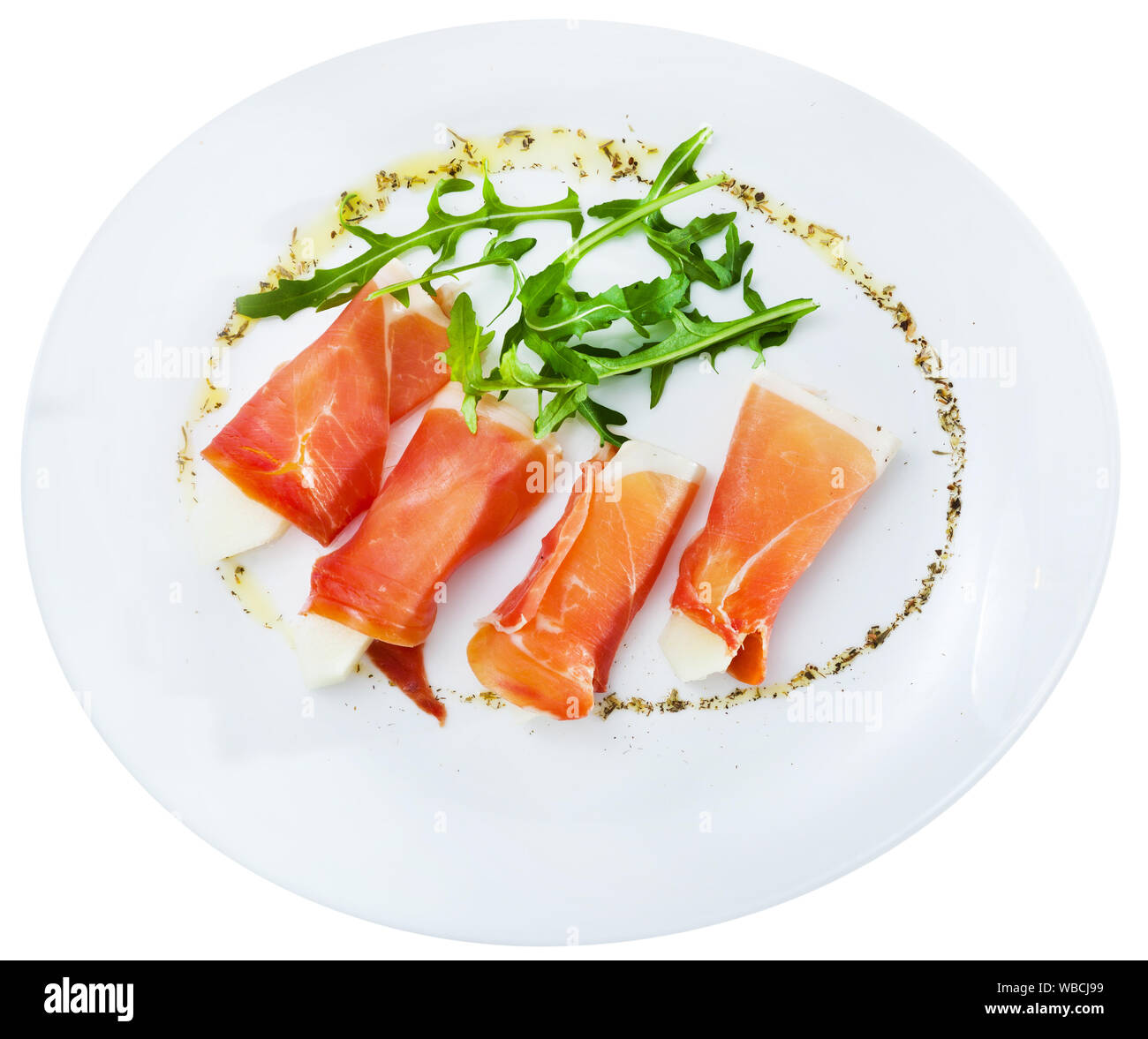 Traditional Spanish dish – jamon with slice of fresh melon. Isolated ...