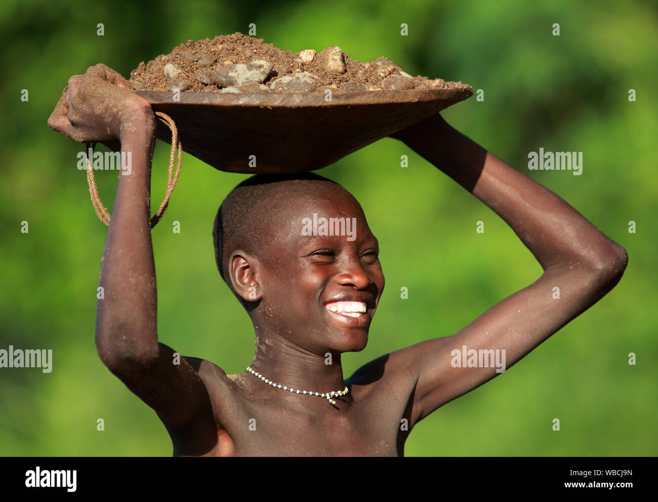 Young Suri man digging gold in South Omo, Ethiopia Stock Photo - Alamy