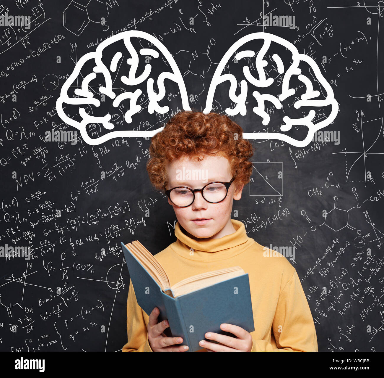 Smart child student wearing glasses holding book and learning science ...