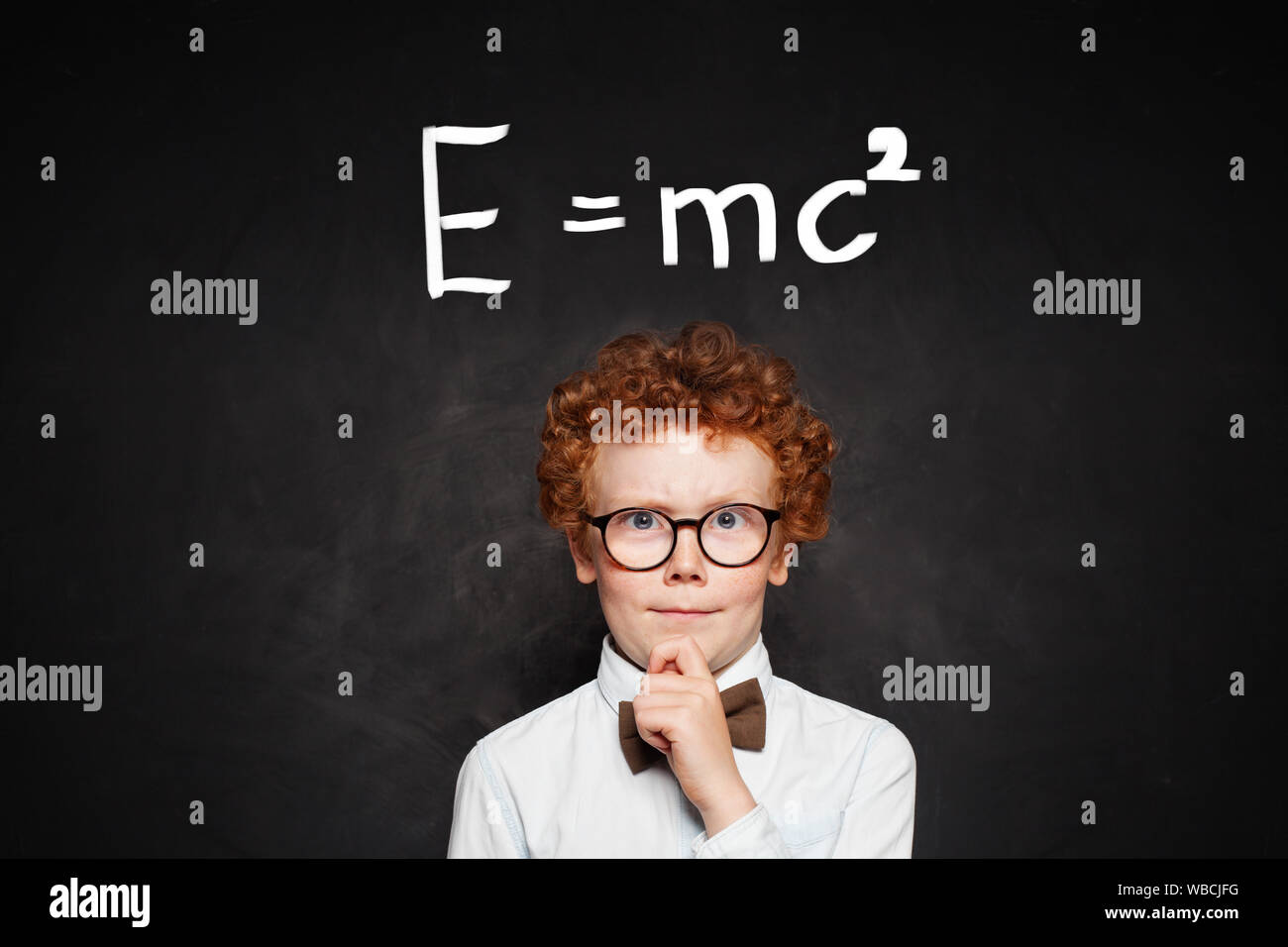 Little genius portrait. Young child boy student on chalkboard with ...