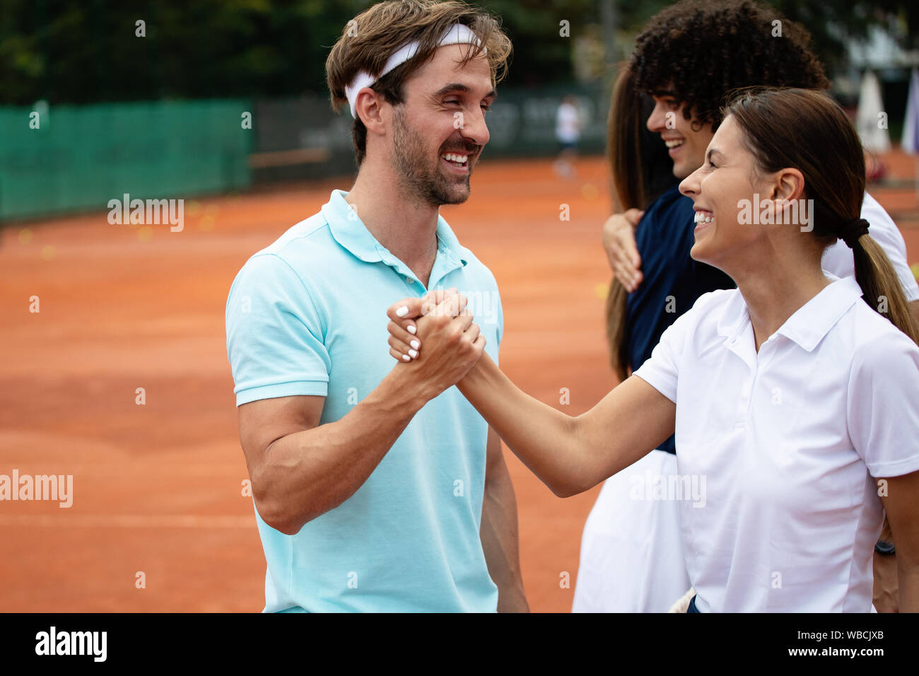 Group of healthy happy friends at the club playing tennis Stock Photo ...