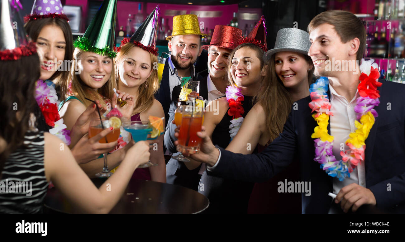 Adult men and women celebrating birthday in the bar at evening Stock ...