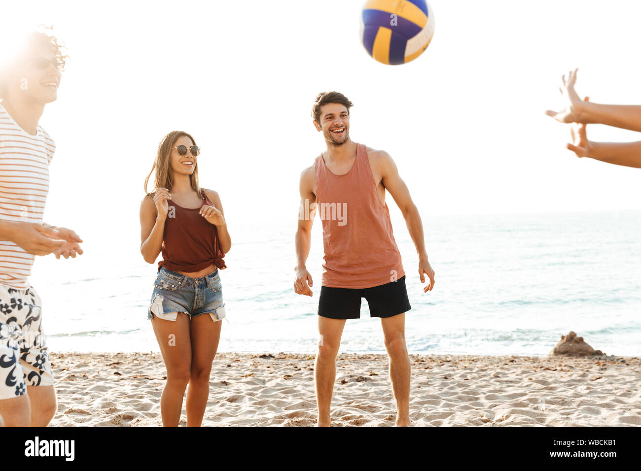Friends playing beach volleyball together hi-res stock photography and ...