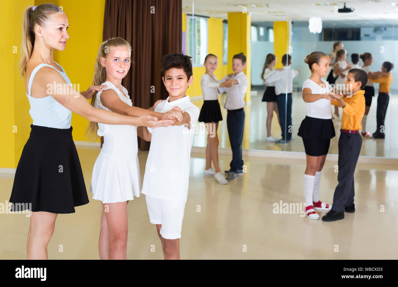 Teacher is demonstrating to kids how to dance tango in class Stock ...