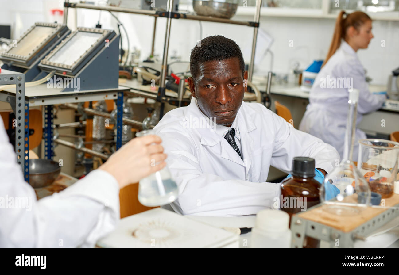 Helping scientist hi-res stock photography and images - Alamy