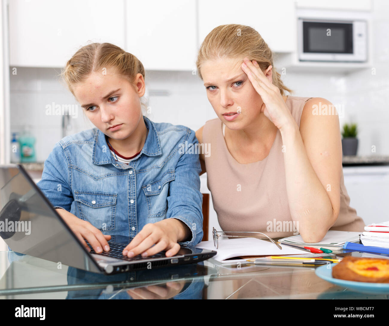 Strict mother checking poorly done home task of her daughter at kitchen ... Strict mother checking poorly done home task of her daughter at kitchen ...