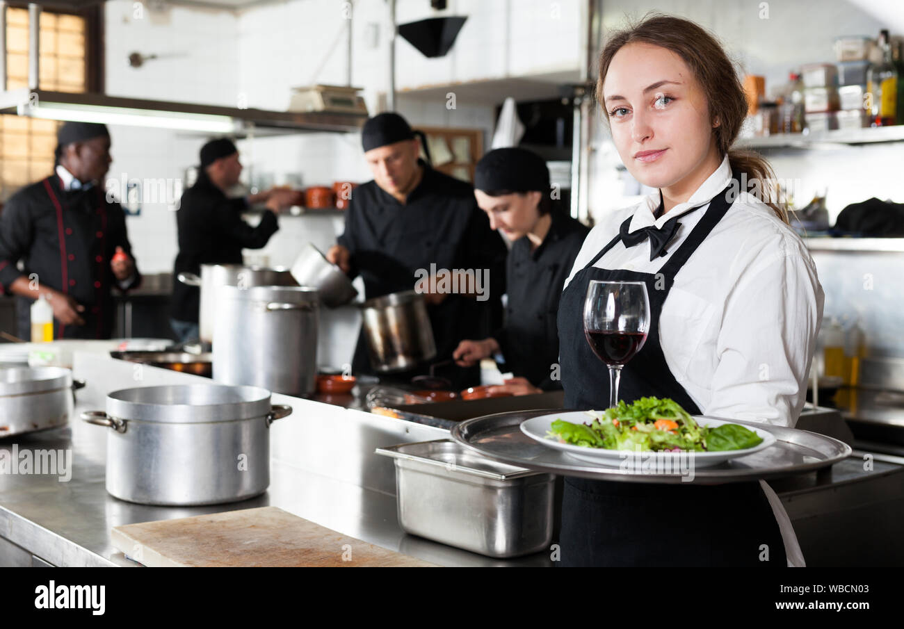 Professional Waitress Holding Serving Tray At Restaurant Kitchen Stock