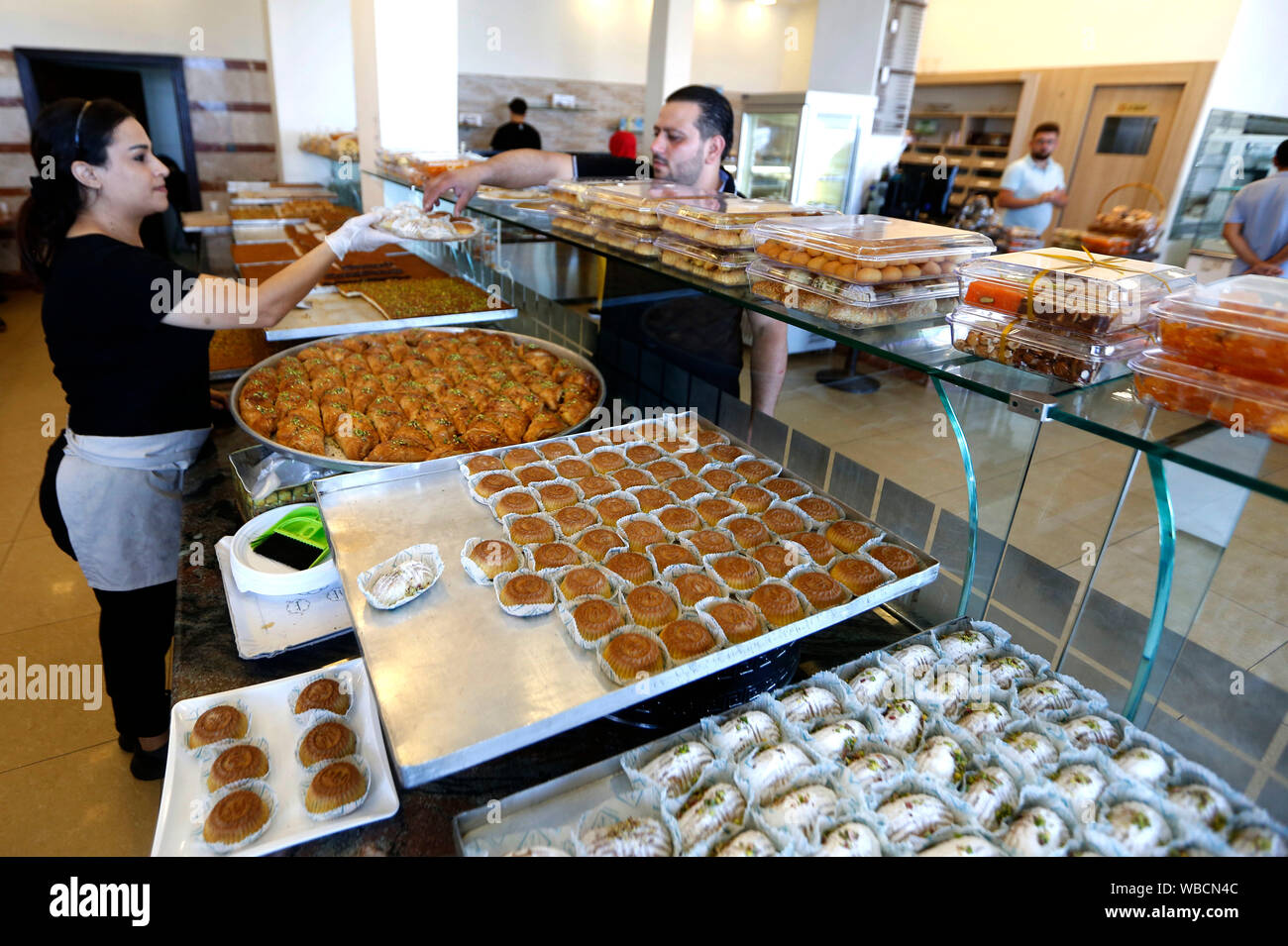 Beirut, Lebanon. 25th Aug, 2019. A customer buys maamoul cakes at a ...