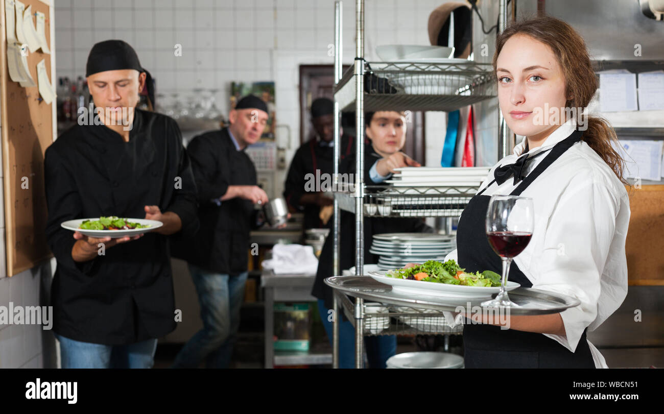 Professional Waitress Holding Serving Tray At Restaurant Kitchen Stock