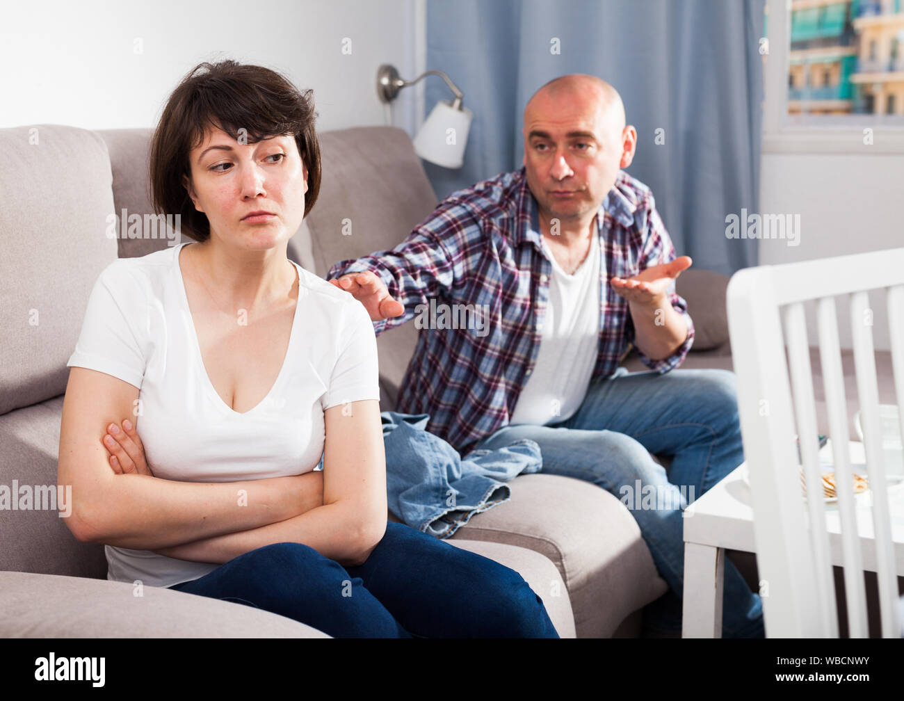 Sad family having difficulties in the living room at home Stock Photo ...