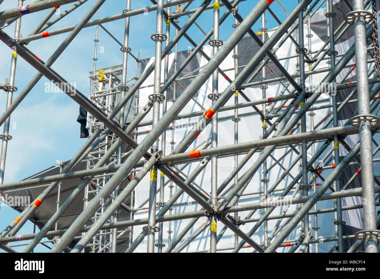 Metal pipe frame structure on blue sky background. Industrial ...