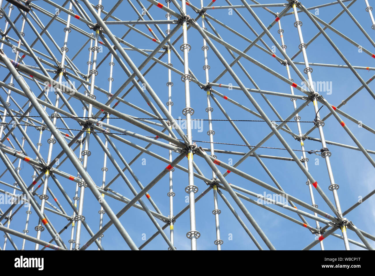 Metal pipe frame structure on blue sky background. Industrial ...